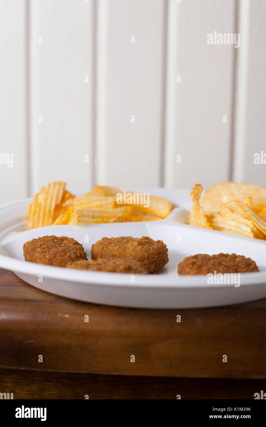 Four chicken nuggets and two stacks of potato chips Stock Photo - Alamy