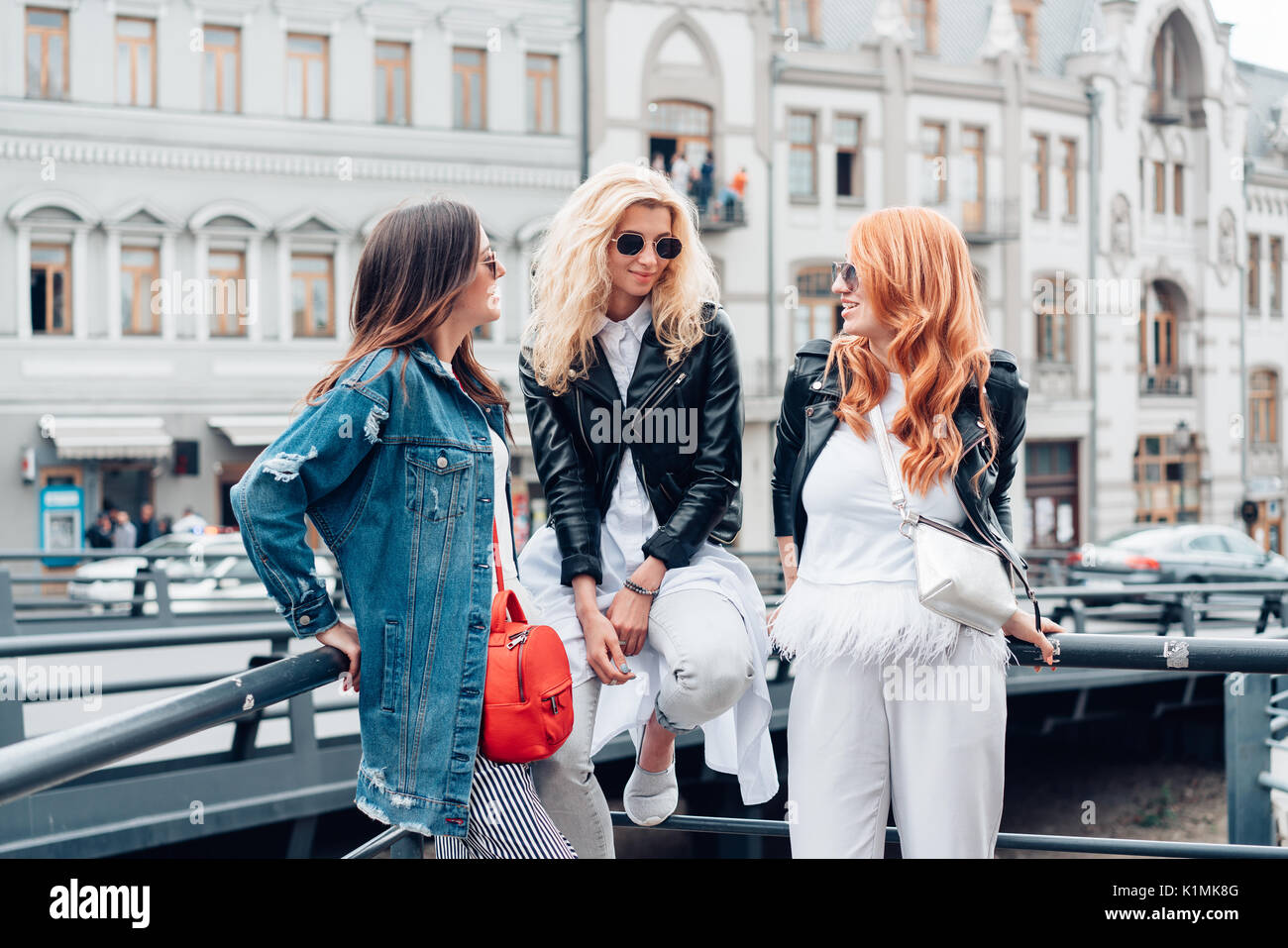 Three women are posing on the street city Stock Photo - Alamy