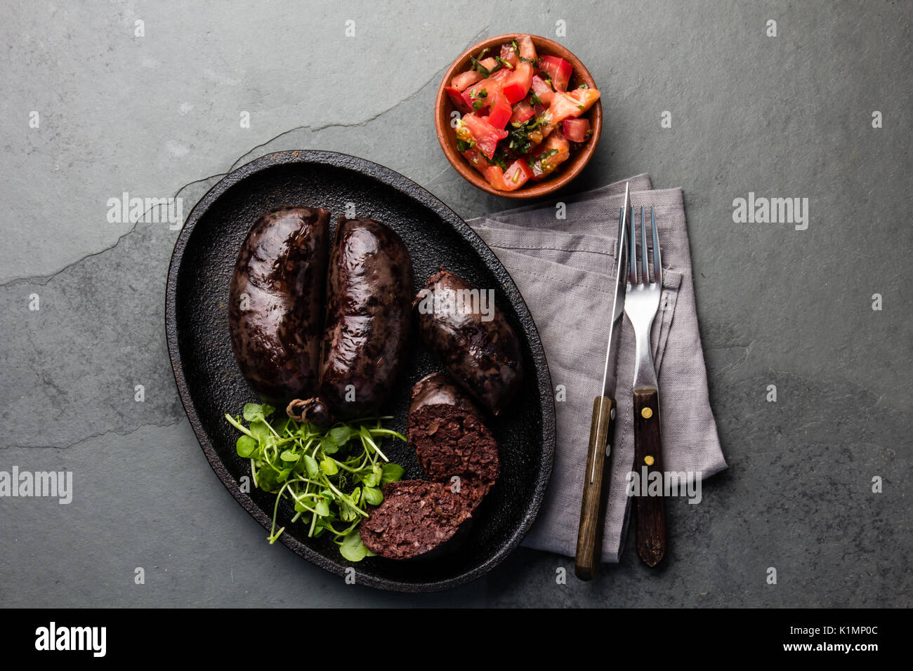 Bloody sausages - chilean preta on black iron plate, top view, grey ...