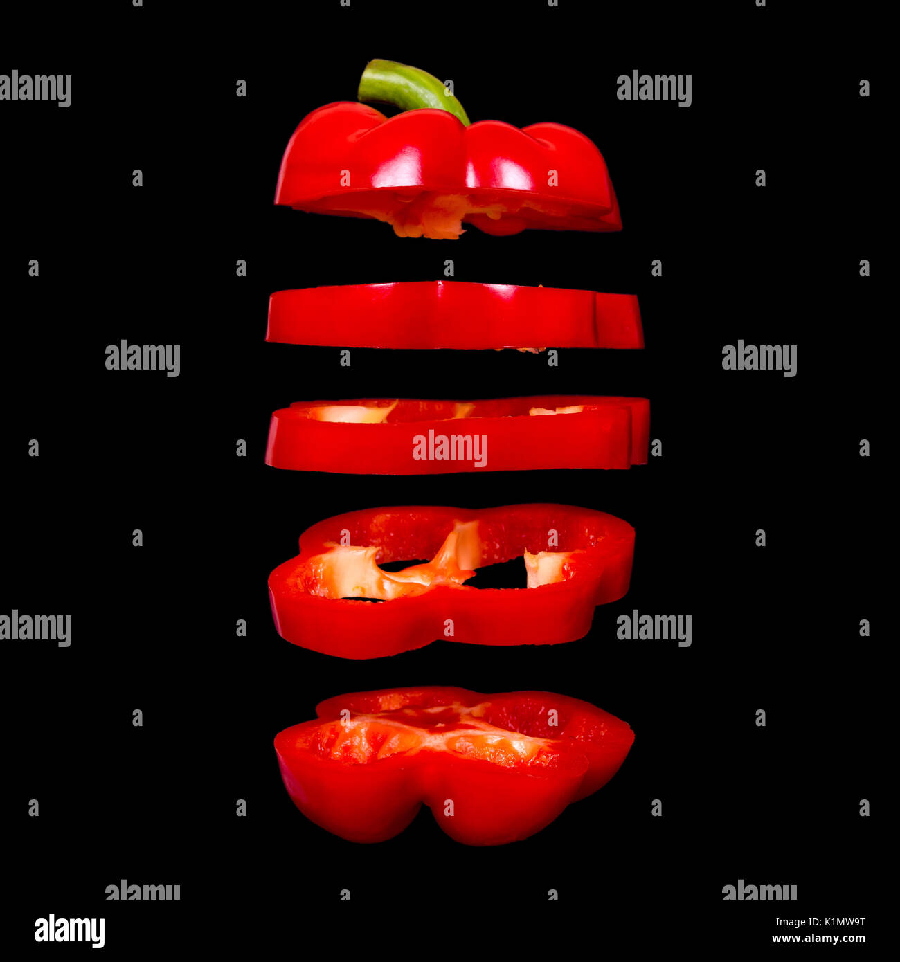 Creative concept with flying red paprika. Sliced floating pepper ...