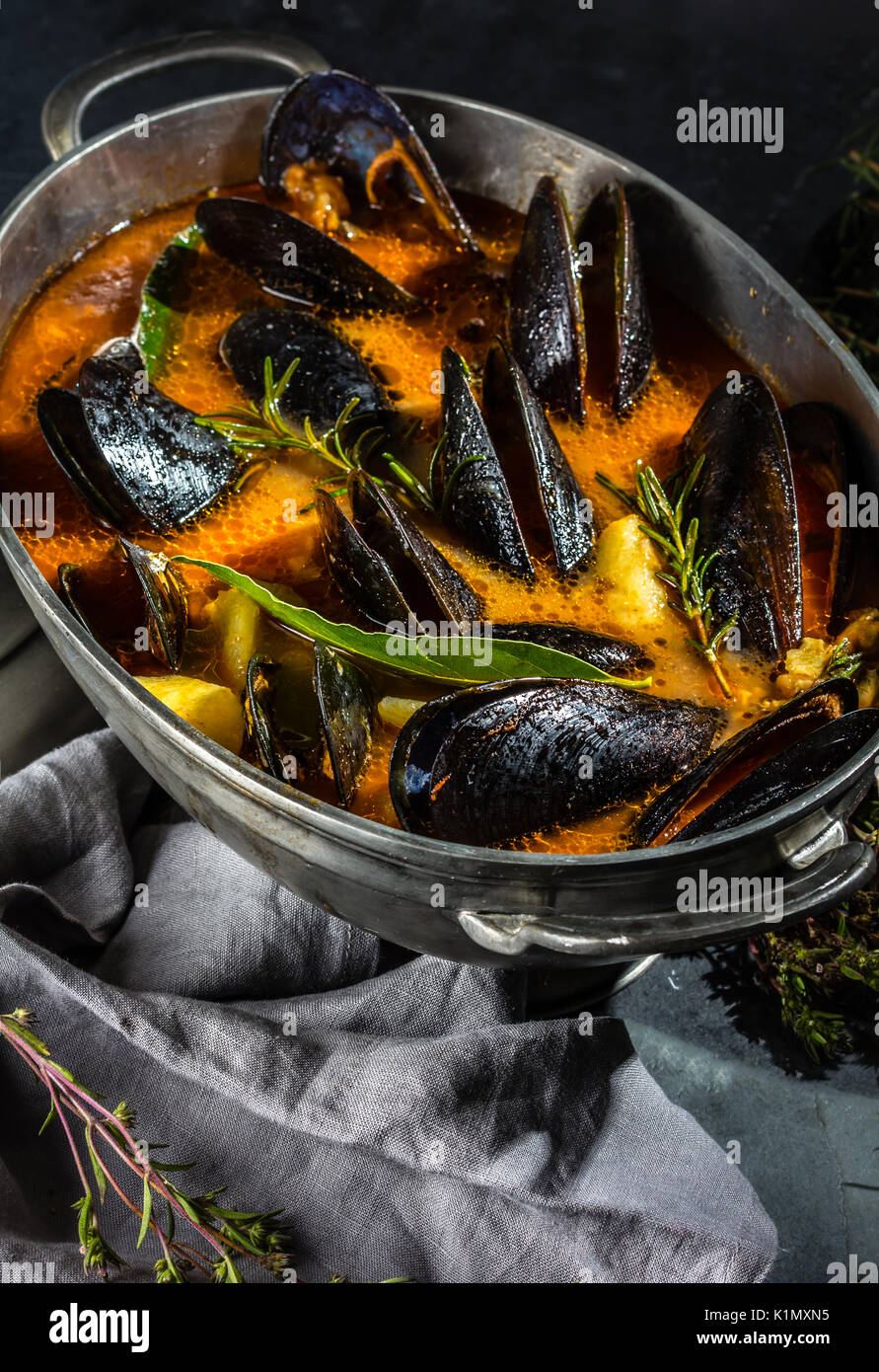 Seafood mussels tomato soup in metal pot, gray background Stock Photo ...