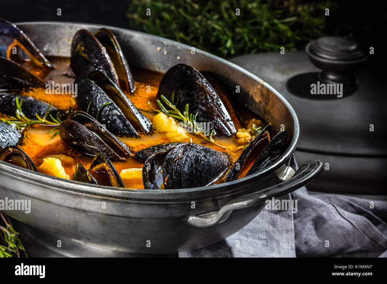 Seafood mussels tomato soup in metal pot, gray background Stock Photo ...