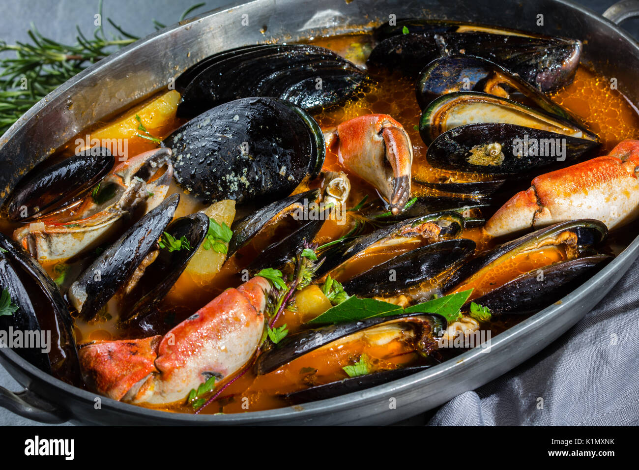Seafood mussels crabs soup in metal pot, gray background Stock Photo ...