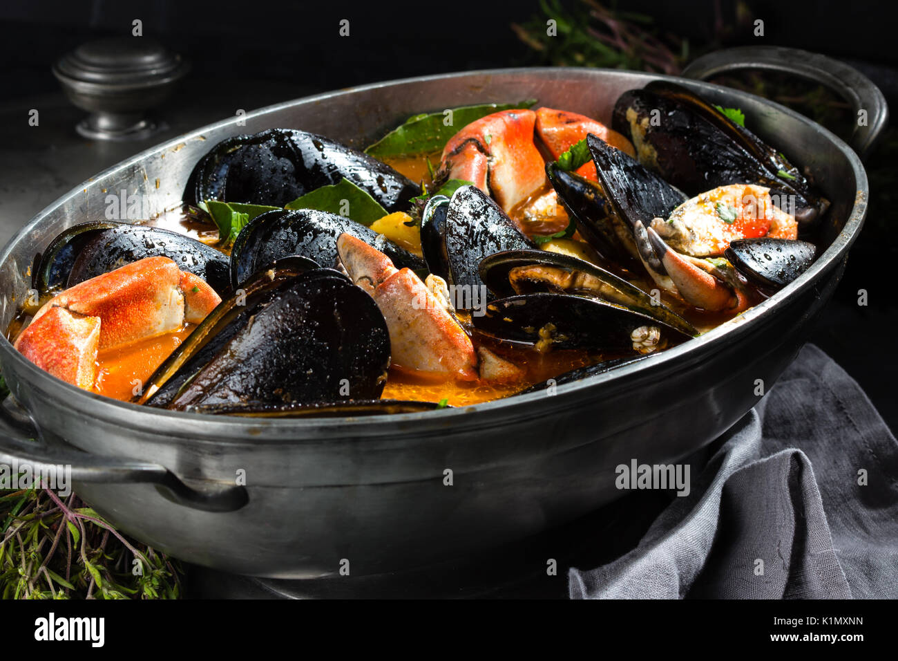 Seafood mussels crabs soup in metal pot, gray background Stock Photo ...