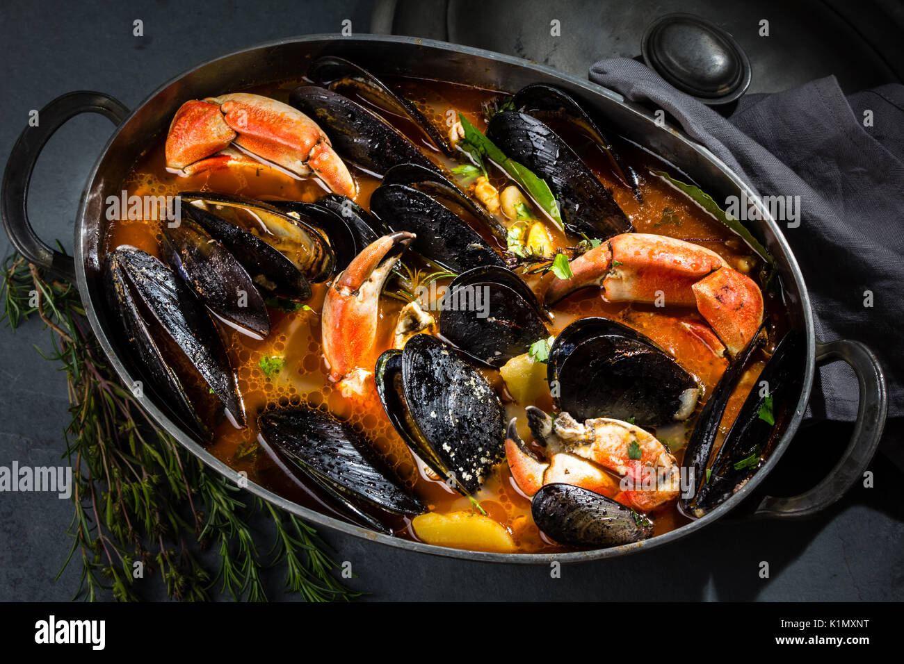 Seafood mussels crabs soup in metal pot, gray background Stock Photo ...