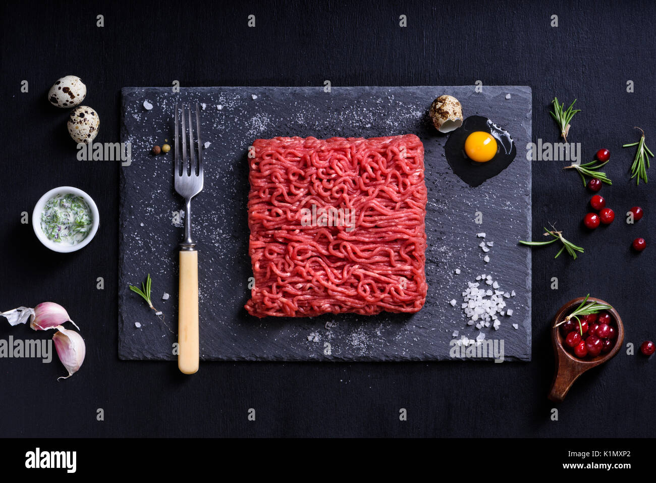 Fresh butcher cut meat minced, garnished, served with cooking ...