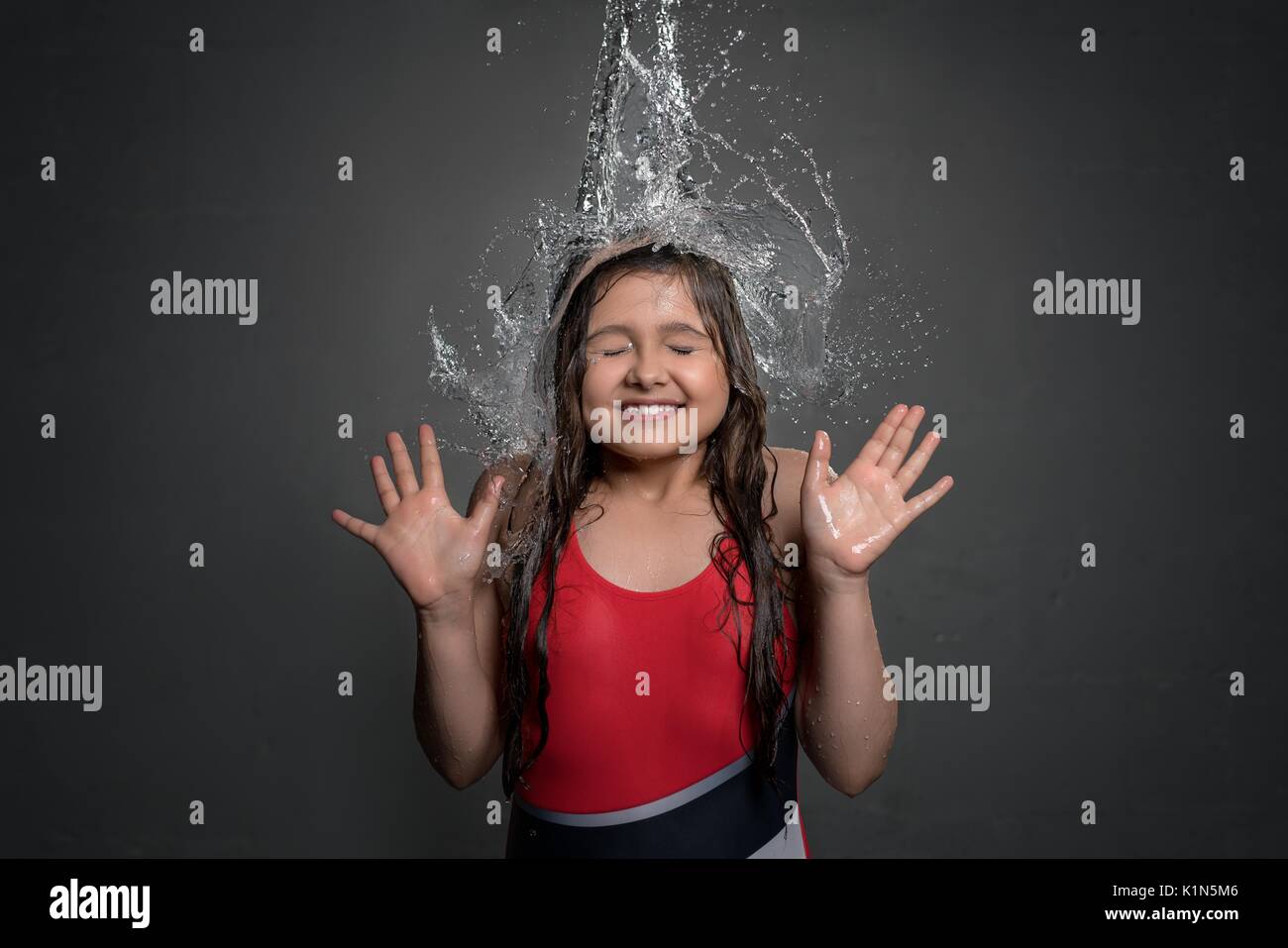 Teenage girl catching water stream from top Stock Photo - Alamy