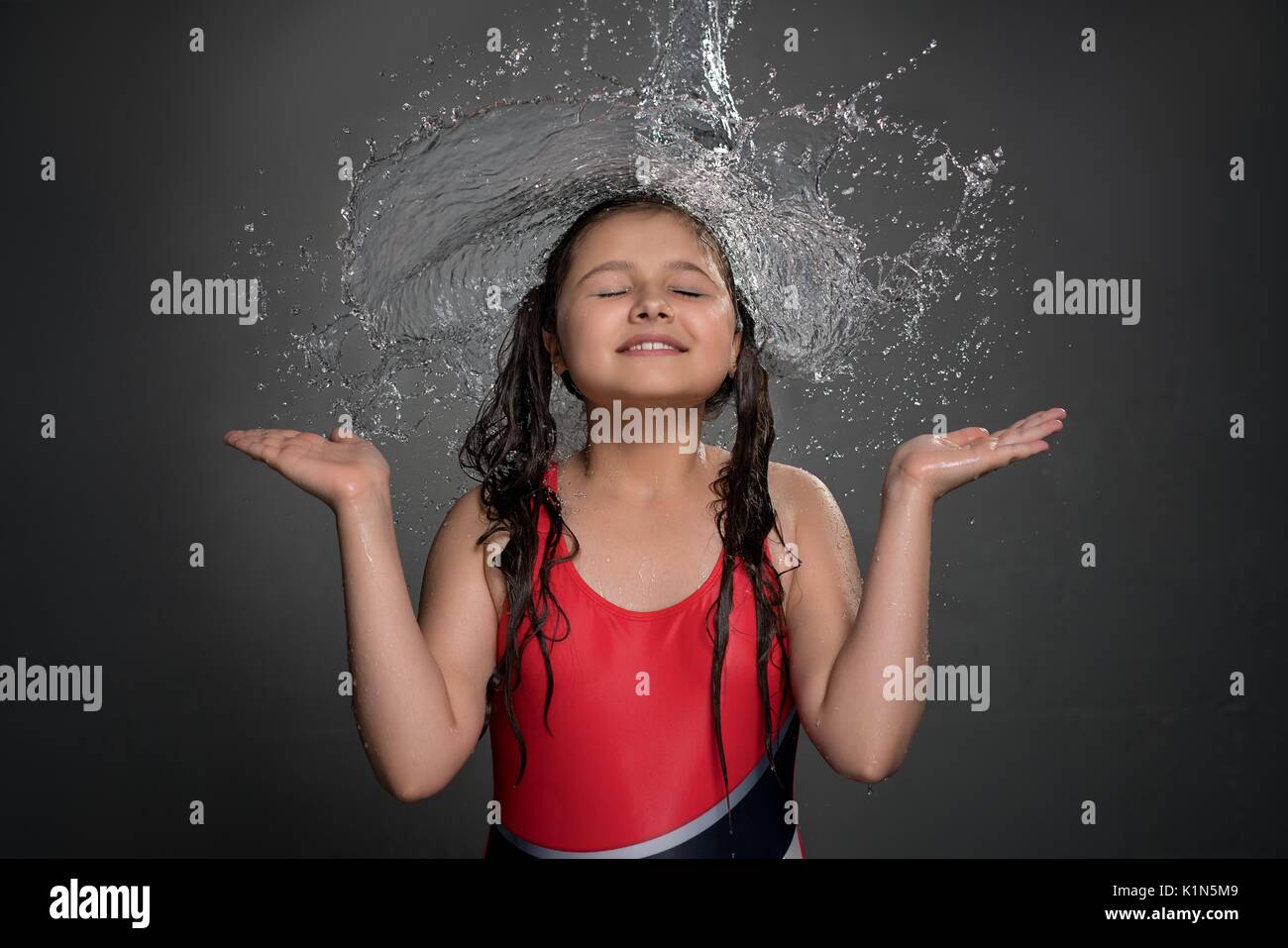 Young girl catching water stream from top Stock Photo - Alamy