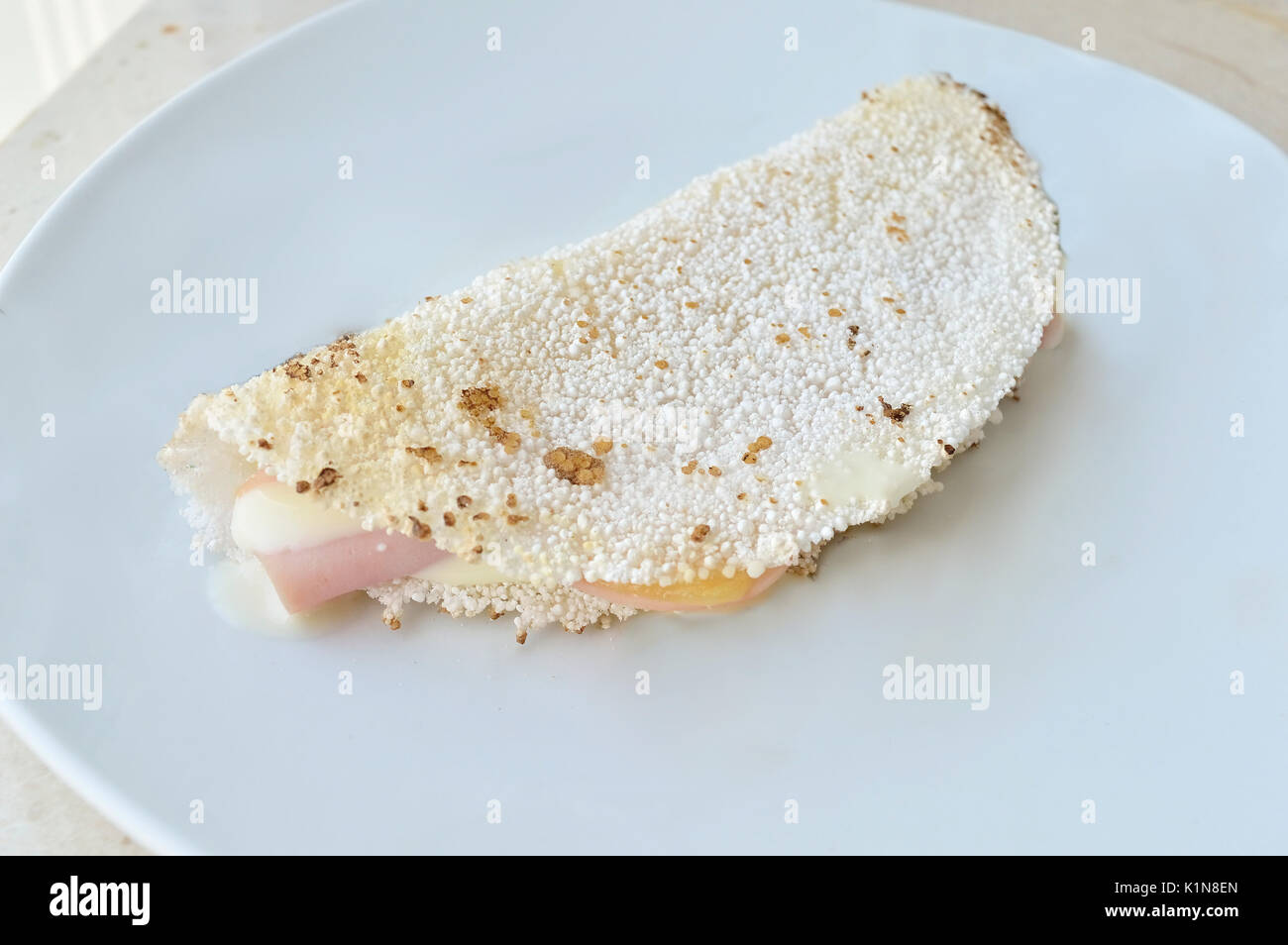 Brazilian typical food from northeast region named "Tapioca" with ham a ...