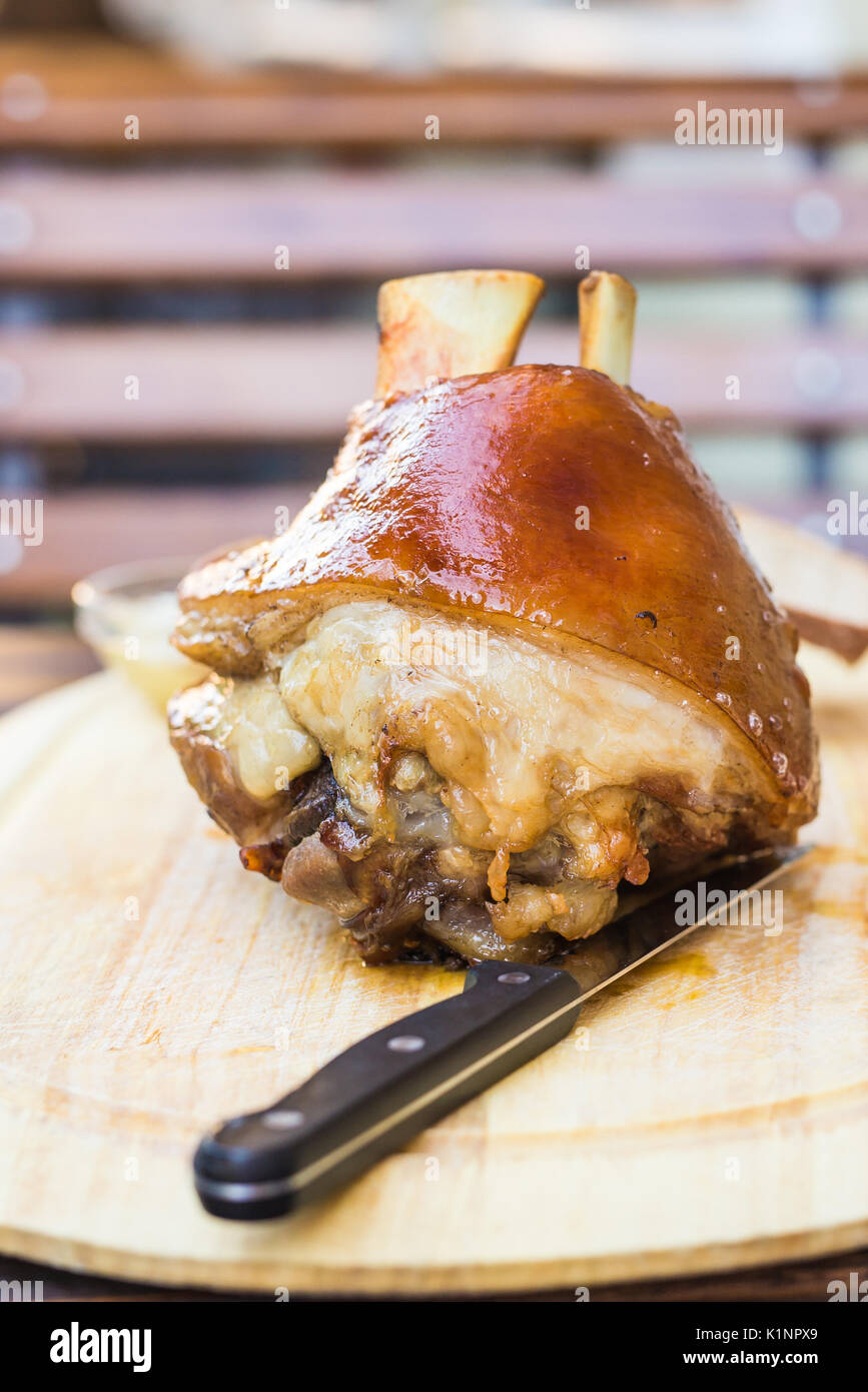 Roasted knuckle of pork on wooden board Stock Photo - Alamy