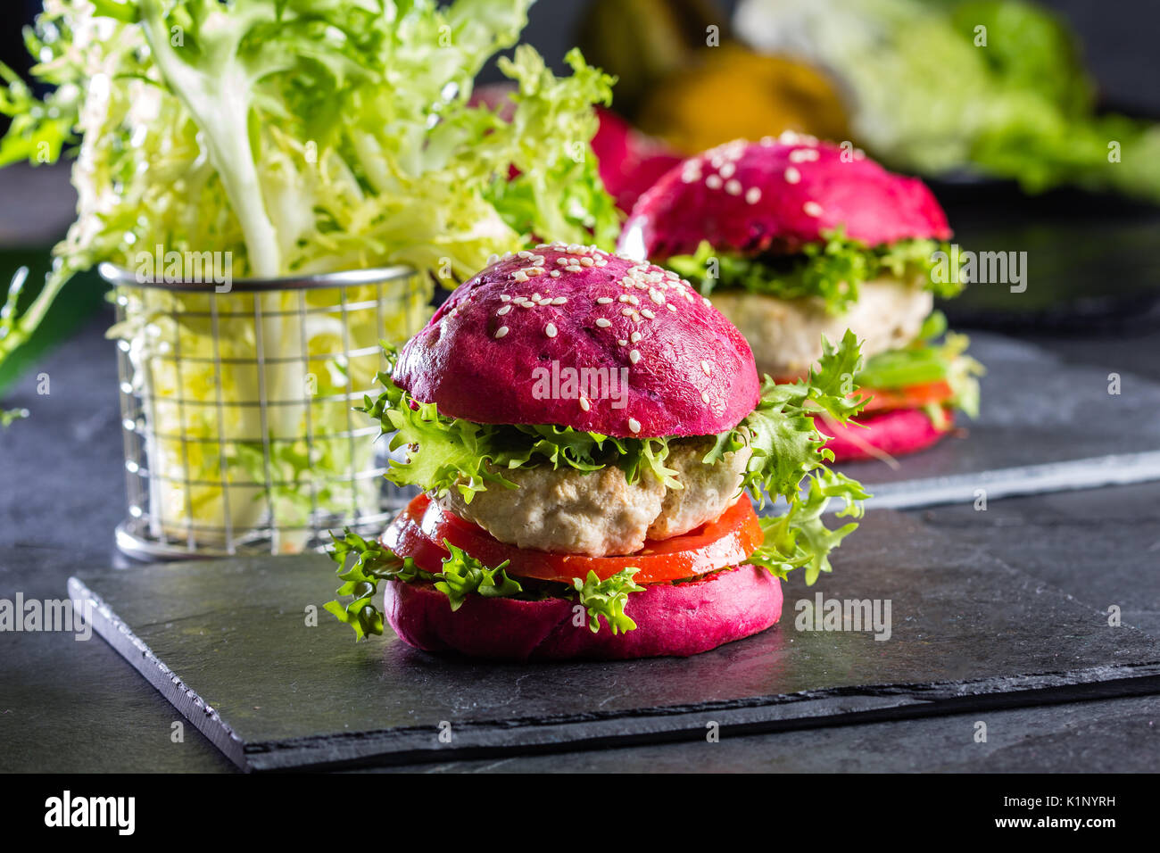 Colored purple beetroot burgers. Chicken burgers hamburgers with ...