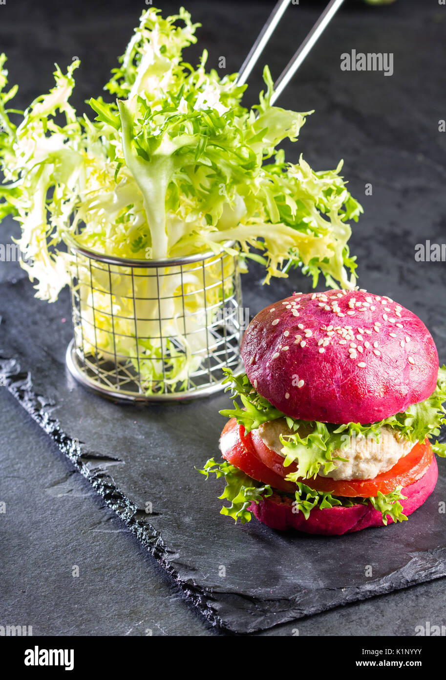 Colored purple beetroot burgers. Chicken burgers hamburgers with ...
