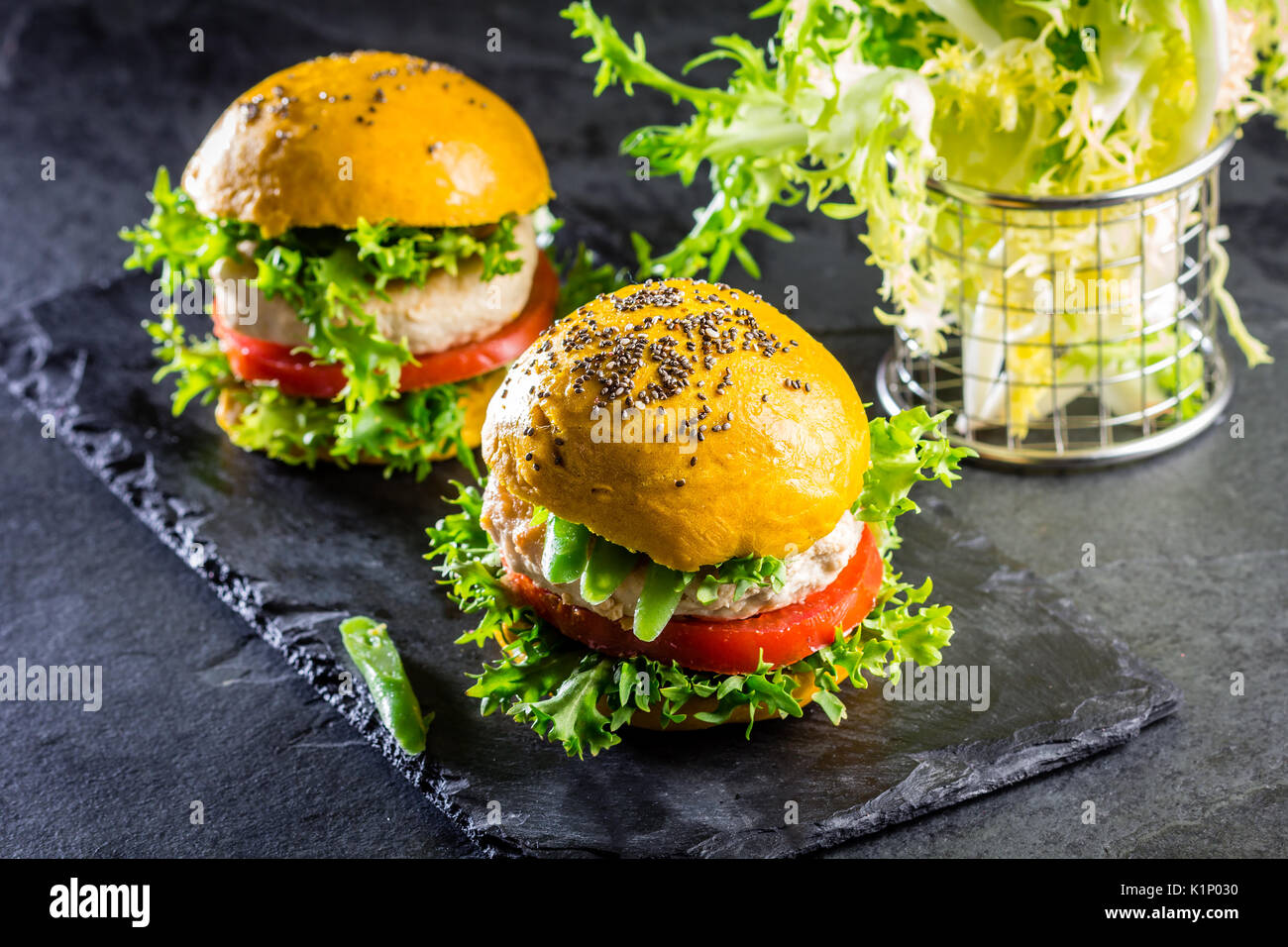 Colored yellow burgers. Homemade American chicken burgers hamburgers ...