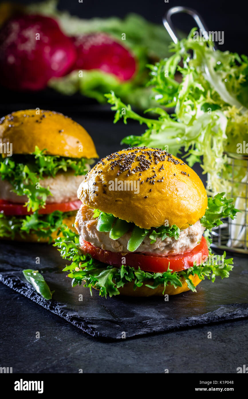 Colored yellow burgers. Homemade American chicken burgers hamburgers ...