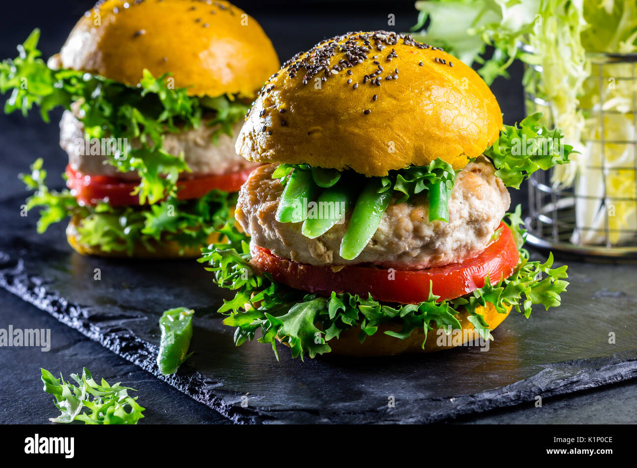 Colored yellow burgers. Homemade American chicken burgers hamburgers ...