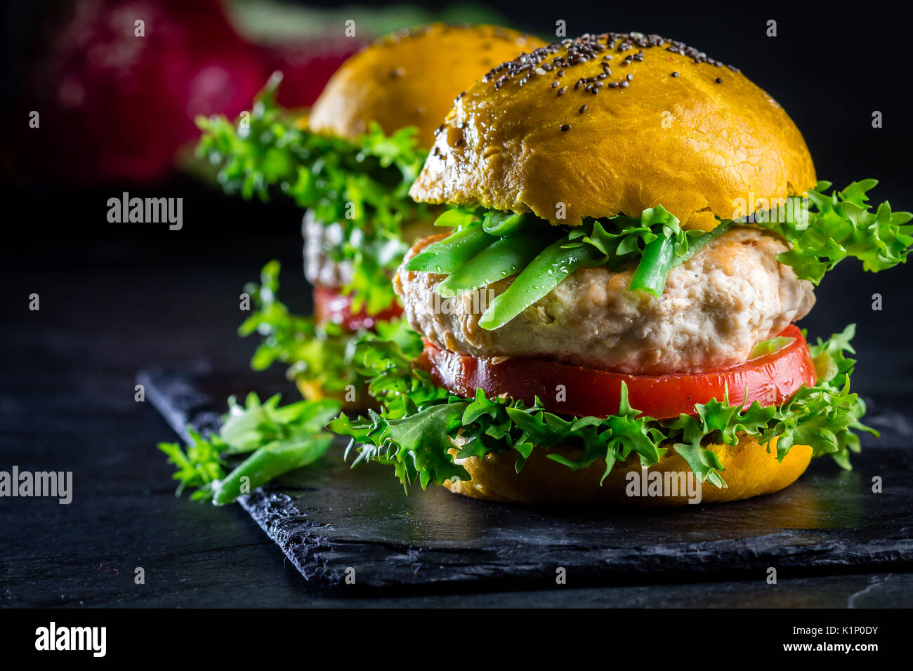 Colored yellow burgers. Homemade American chicken burgers hamburgers ...