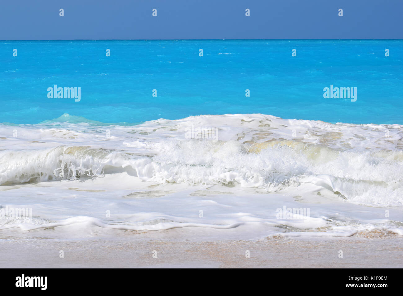 Clear blue sea foam wave Stock Photo - Alamy
