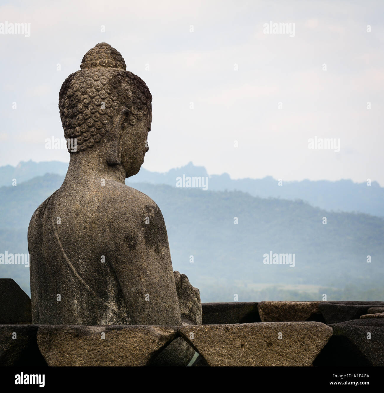Buddha statue at Borobudur Temple with mountain background on Java ...