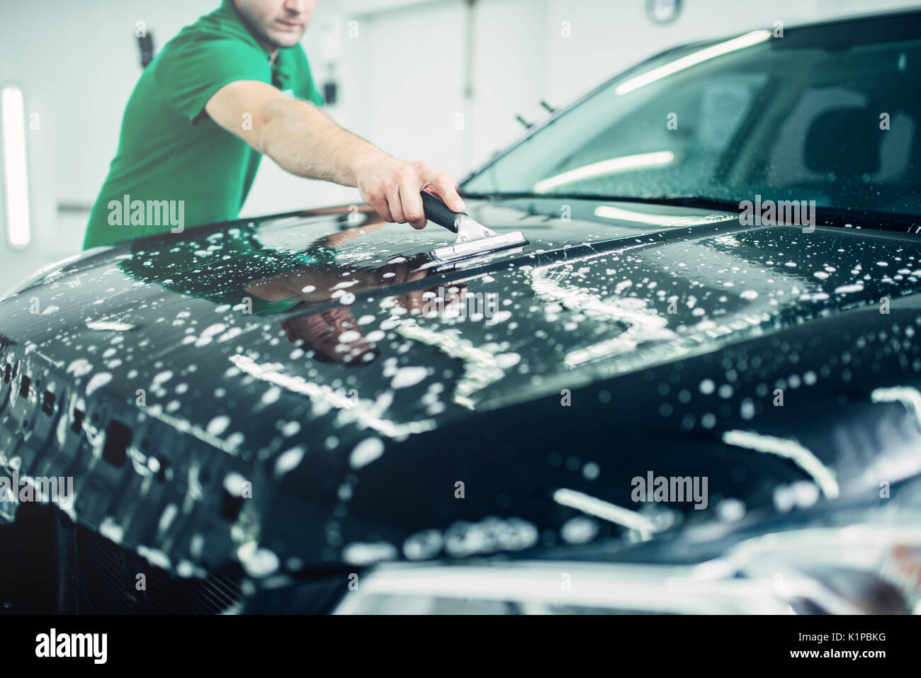 Specialist prepares car for protect against chips and scratches. Paint ...