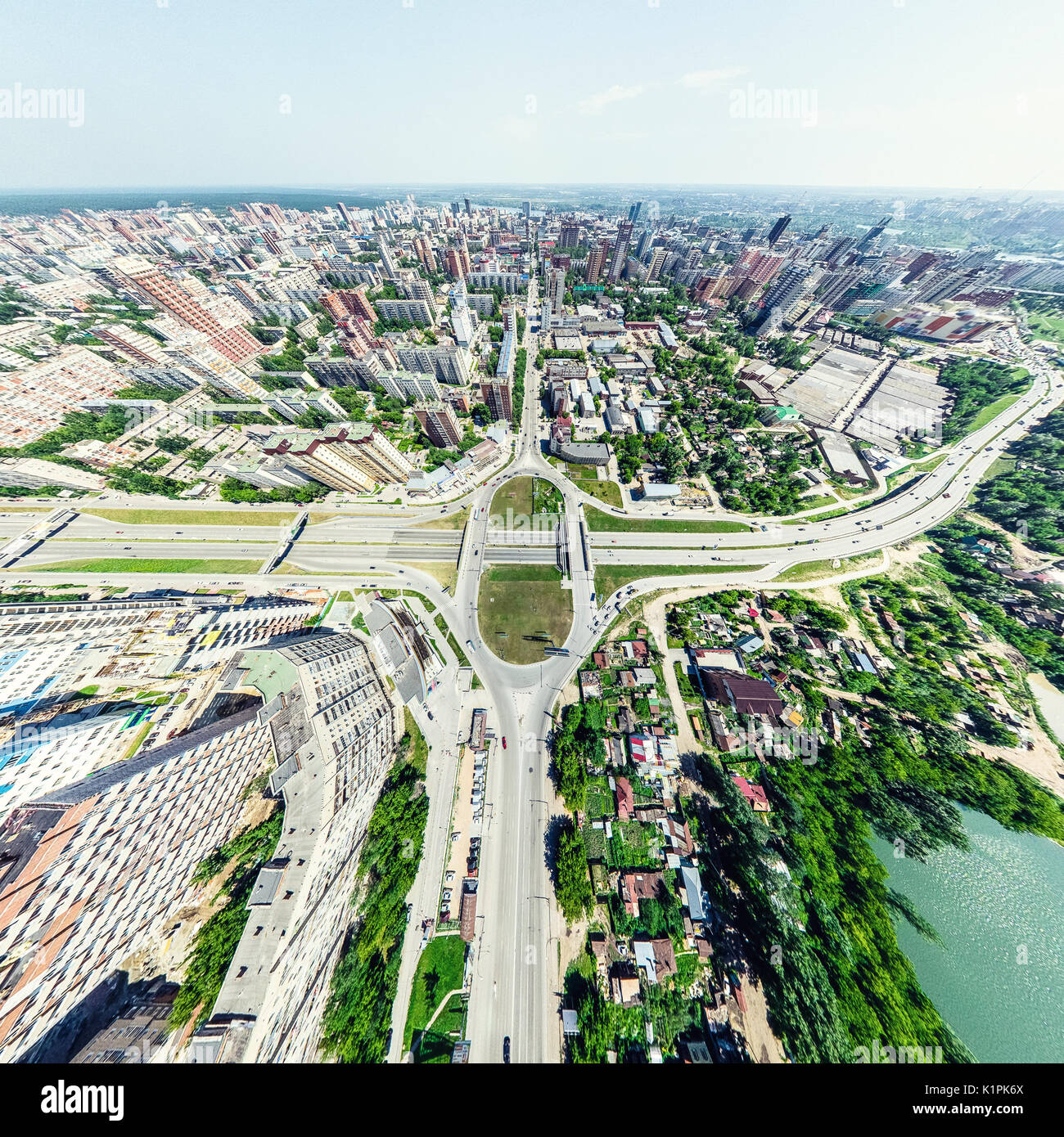Aerial city view with crossroads and roads, houses, buildings, parks ...