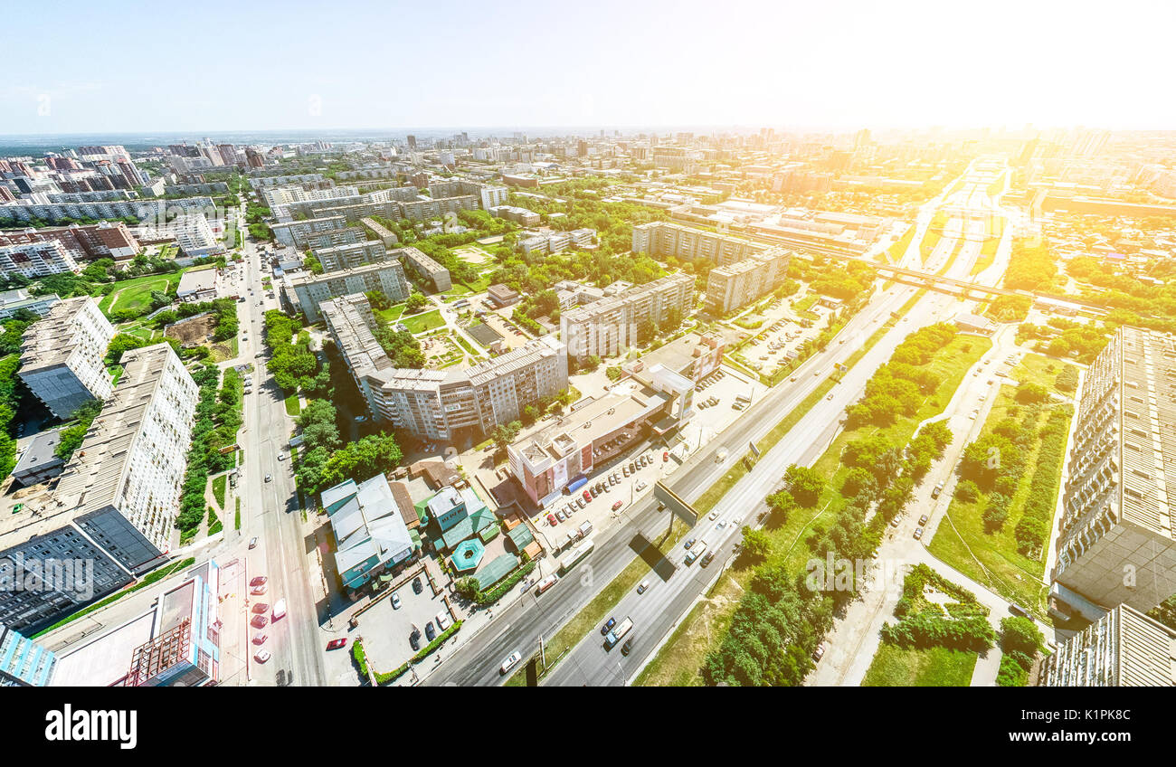 Aerial city view with crossroads and roads, houses, buildings, parks ...