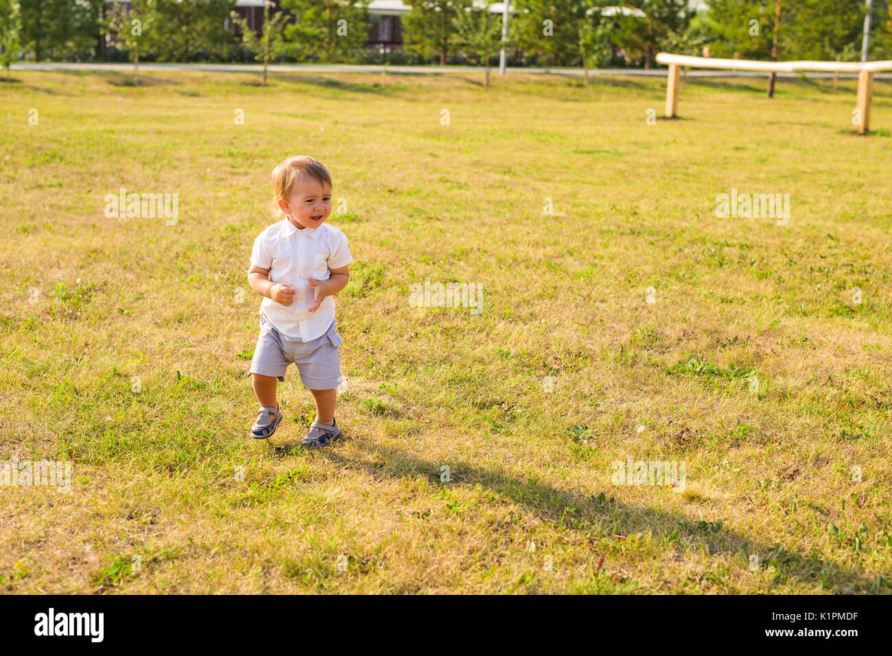 Portrait of cute little baby boy having fun outside. Smiling happy ...