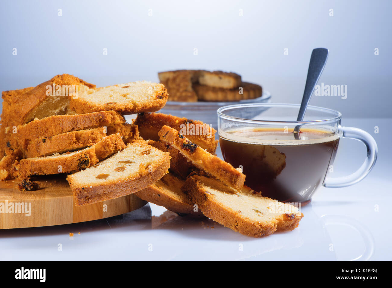 The cake cut on pieces with raisin on a beautiful chopping board and ...