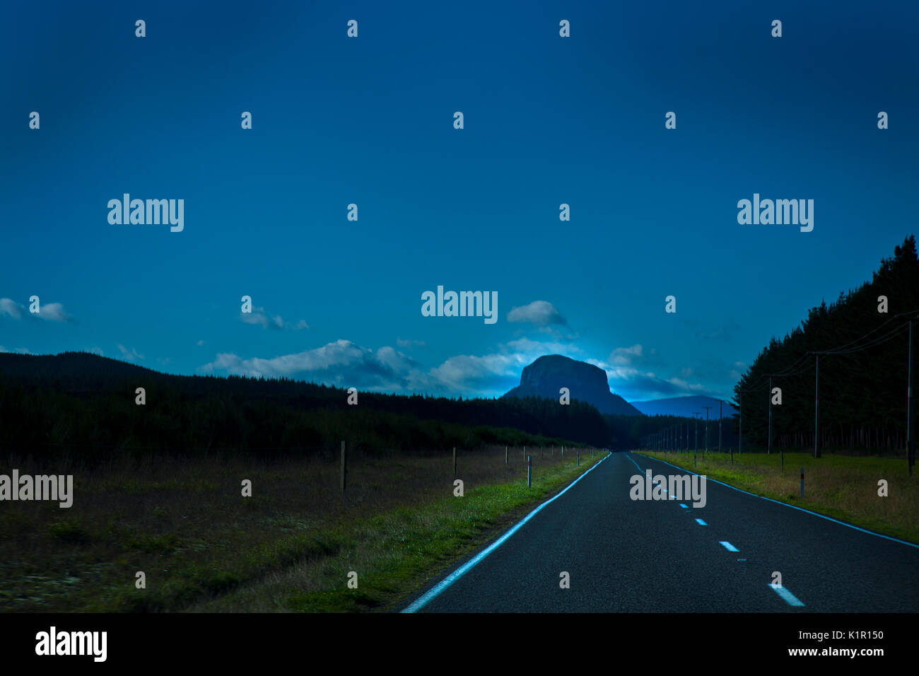 Spooky mountain at end of high way Stock Photo - Alamy