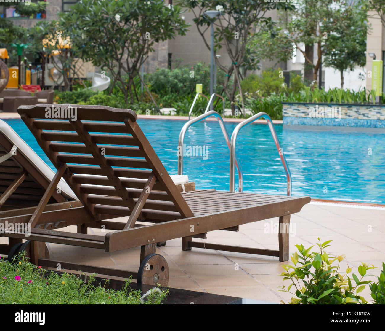 Relaxing chairs at beautiful swimming pool in the tropic resort Stock ...