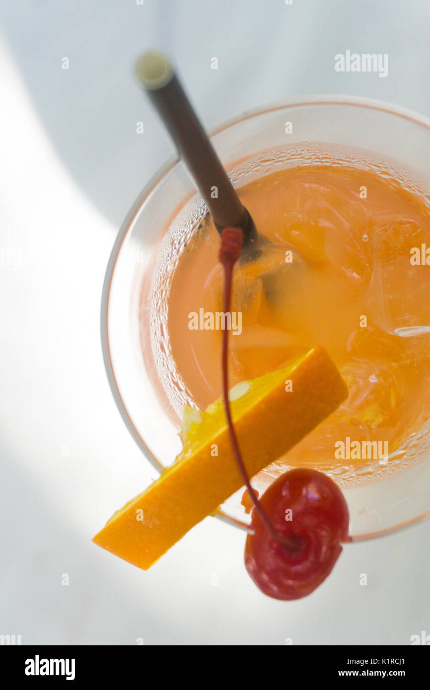 Tropical cocktail with orange and cherry garnish Stock Photo - Alamy