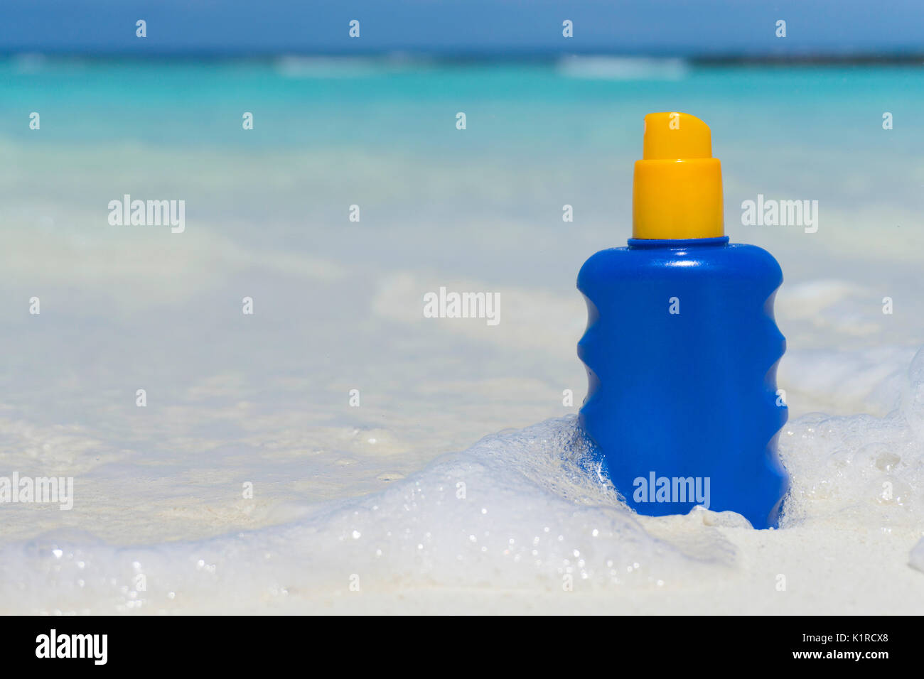 Bottle of sun lotion suncream protection on a tropical beach Stock ...