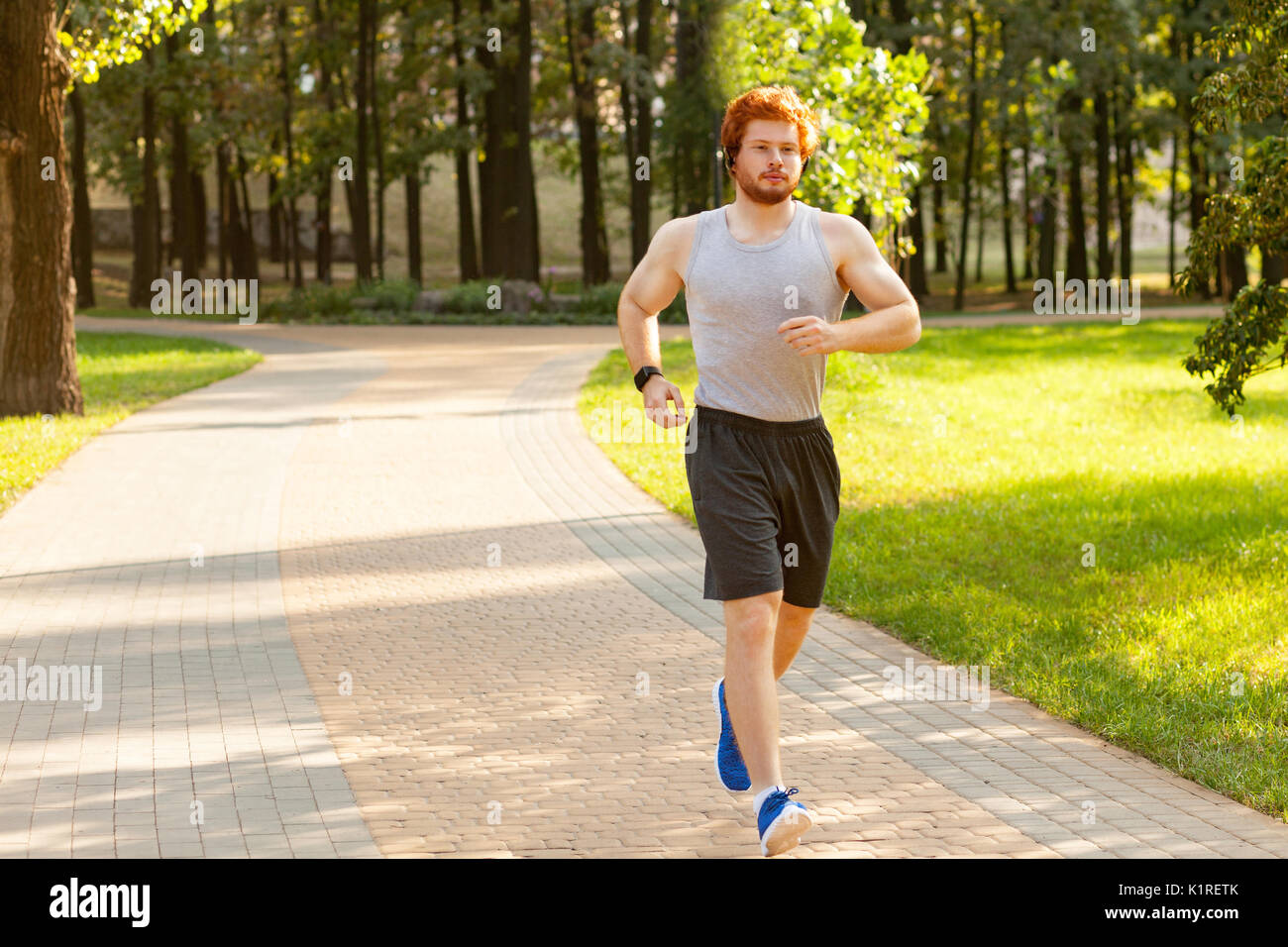 Man running watch park hi-res stock photography and images - Alamy