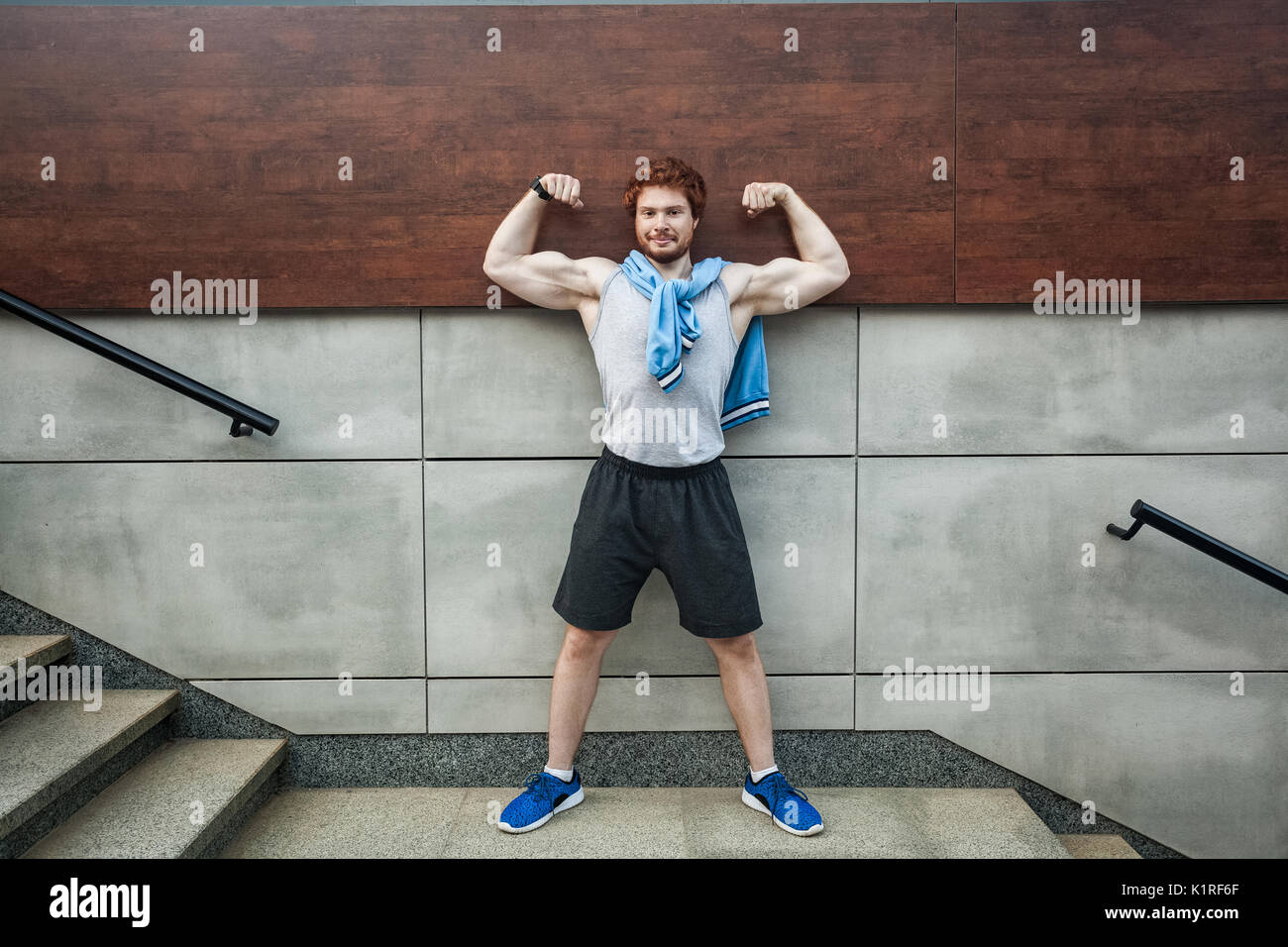 Poses as mister olympya. Show bicep. Smiling and looking at camera ...