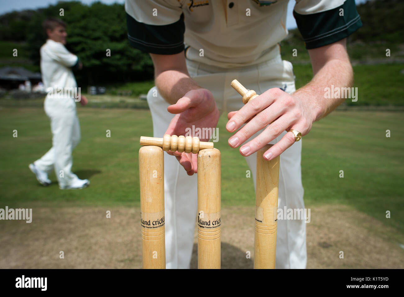 Embargoed to 0001 Monday August 28 A player balances the bails onto the ...