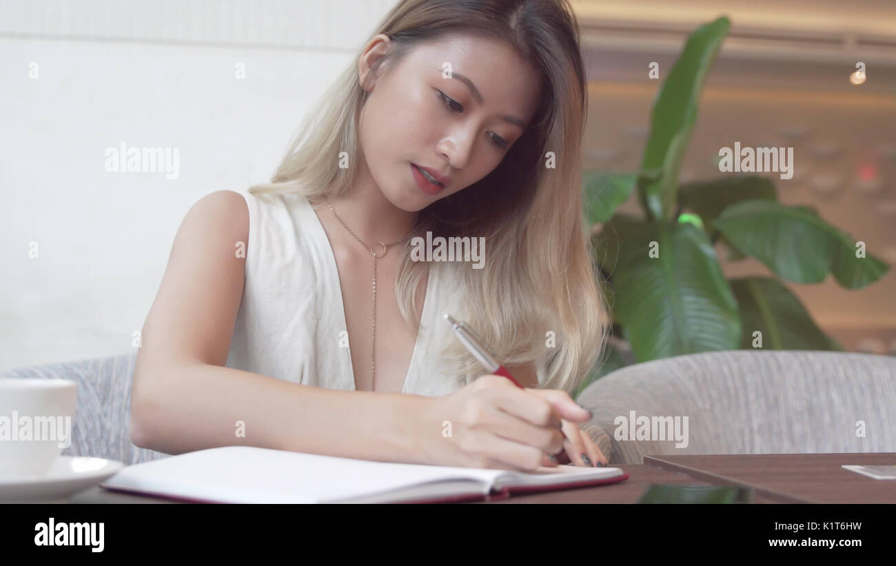 Asian female student learning english language Stock Photo - Alamy