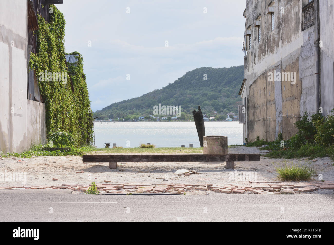 Space between houses beside the sea. There's wooden beach that you can ...