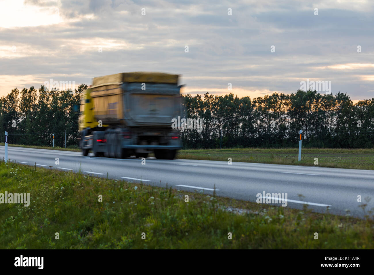 Speeding motion blur oncoming trucks with glowing lights on the highway ... Speeding motion blur oncoming trucks with glowing lights on the highway ...