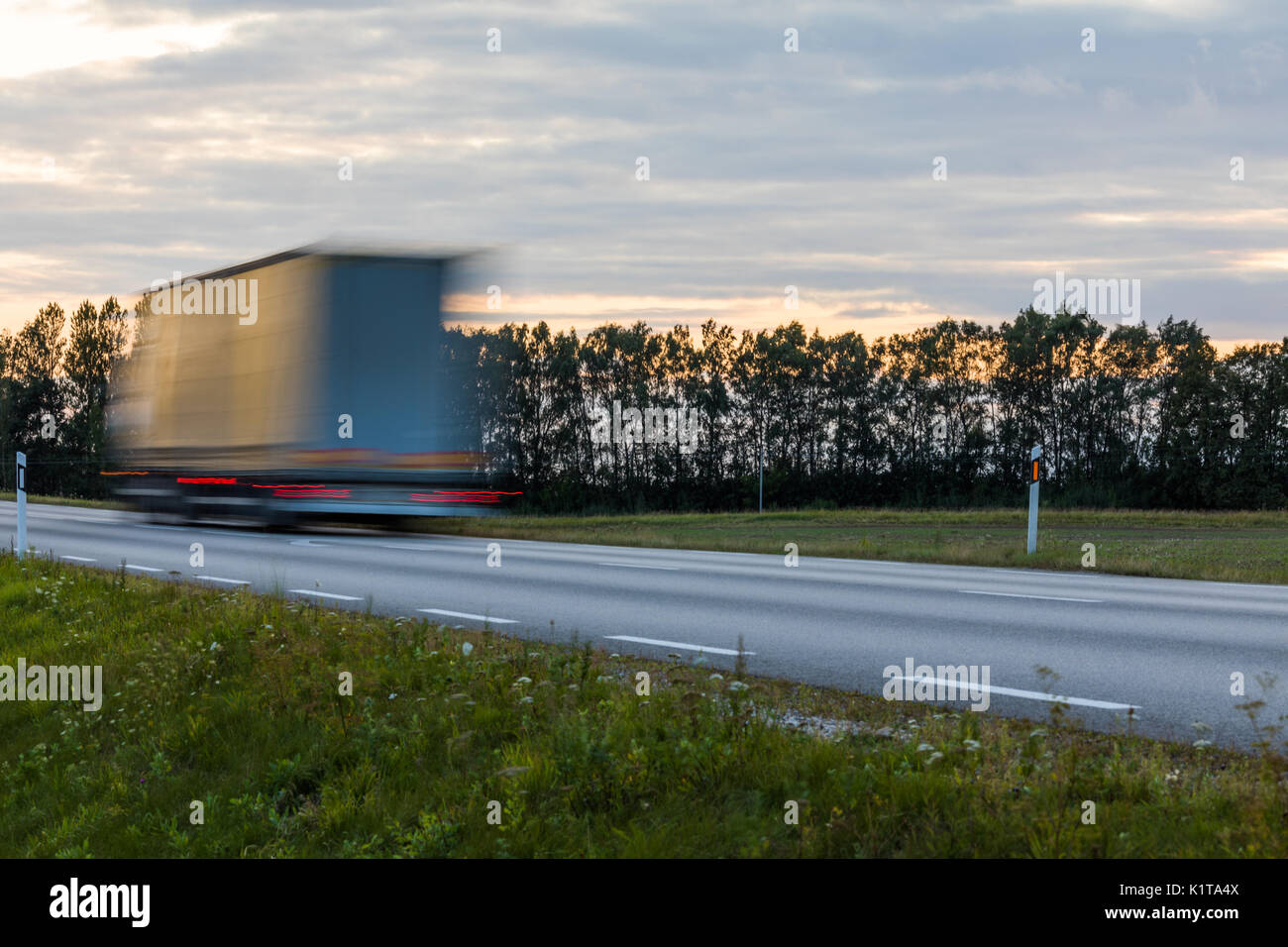Speeding motion blur oncoming trucks with glowing lights on the highway ... Speeding motion blur oncoming trucks with glowing lights on the highway ...