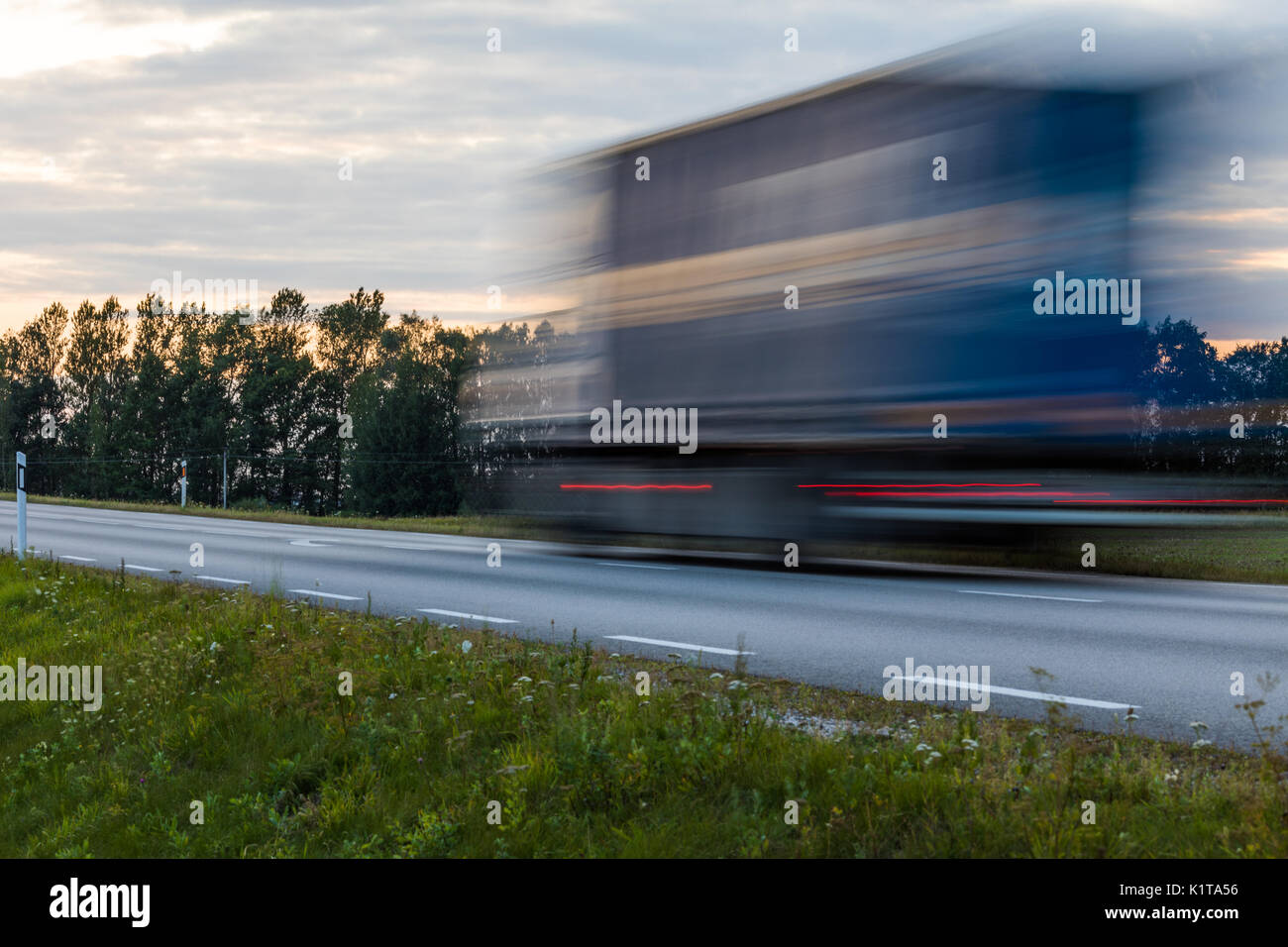 Speeding motion blur oncoming trucks with glowing lights on the highway ... Speeding motion blur oncoming trucks with glowing lights on the highway ...
