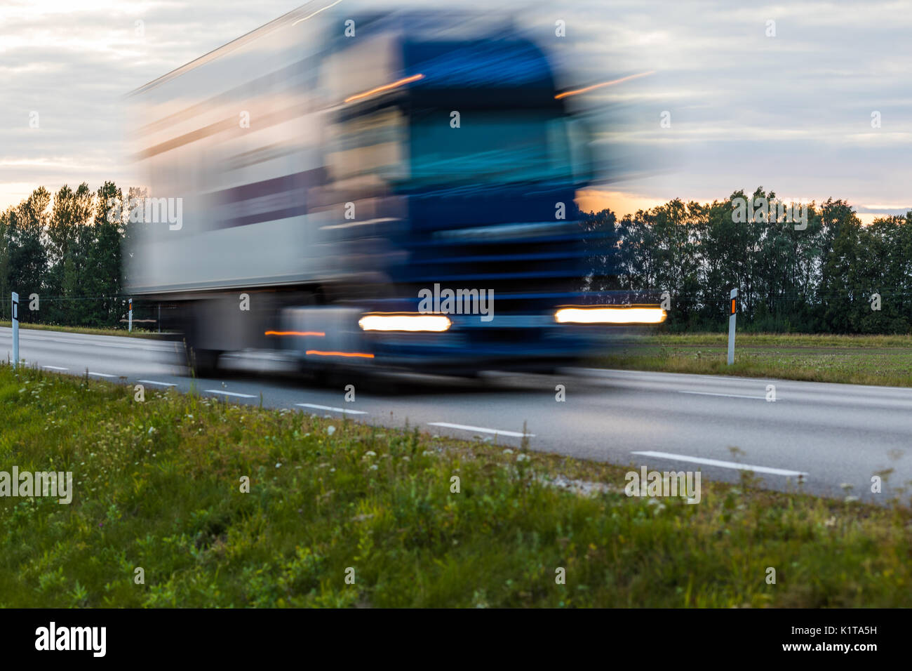 Speeding motion blur oncoming trucks with glowing lights on the highway ... Speeding motion blur oncoming trucks with glowing lights on the highway ...