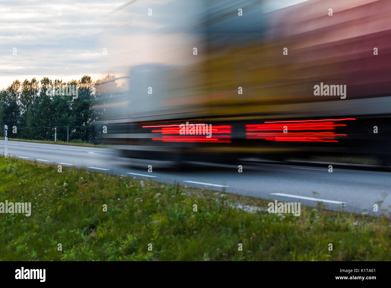 Speeding motion blur oncoming trucks with glowing lights on the highway ... Speeding motion blur oncoming trucks with glowing lights on the highway ...