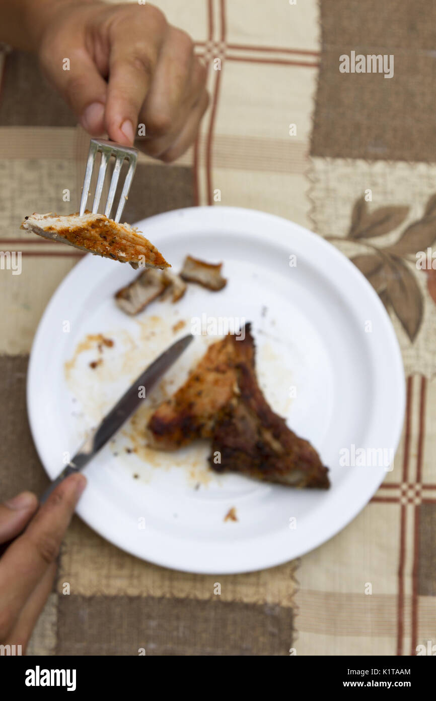 eating stake from plate with fork and knife man hands macro Stock Photo ...