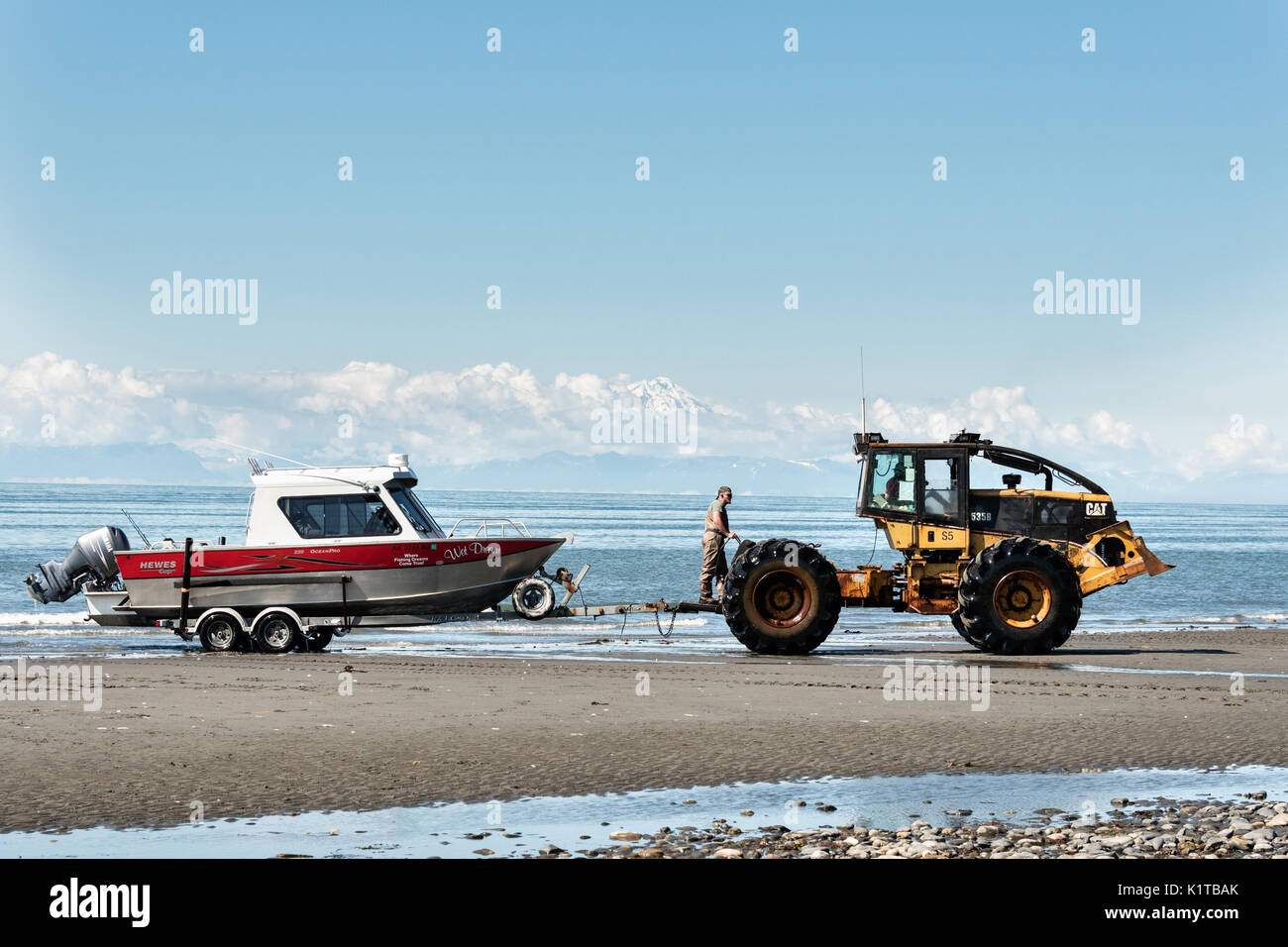 Fishing boats are towed by a tractor tug that will carry them back to ...