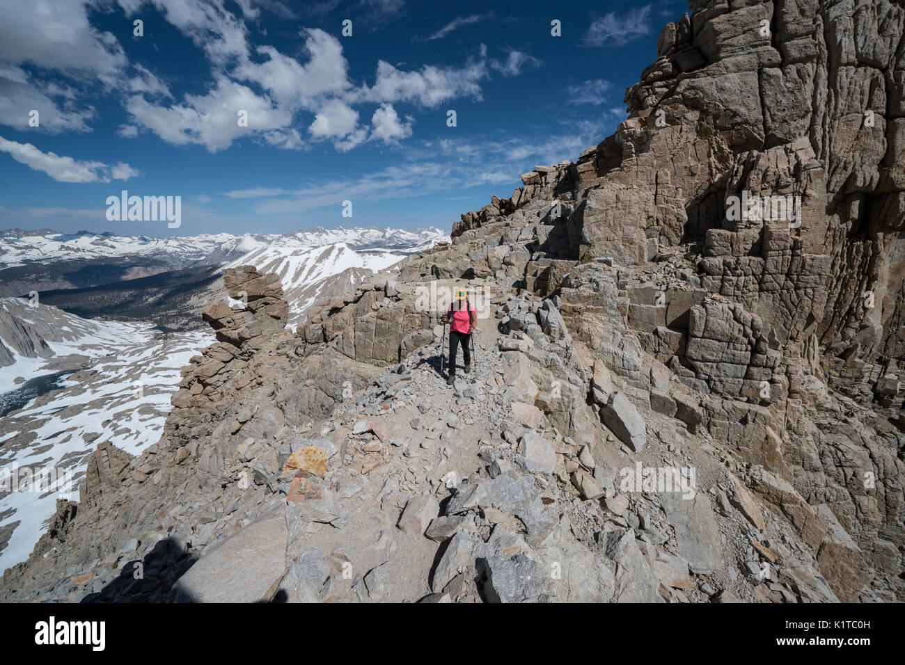 A woman hikes through one of the famous Trail Crest windows on the way ...