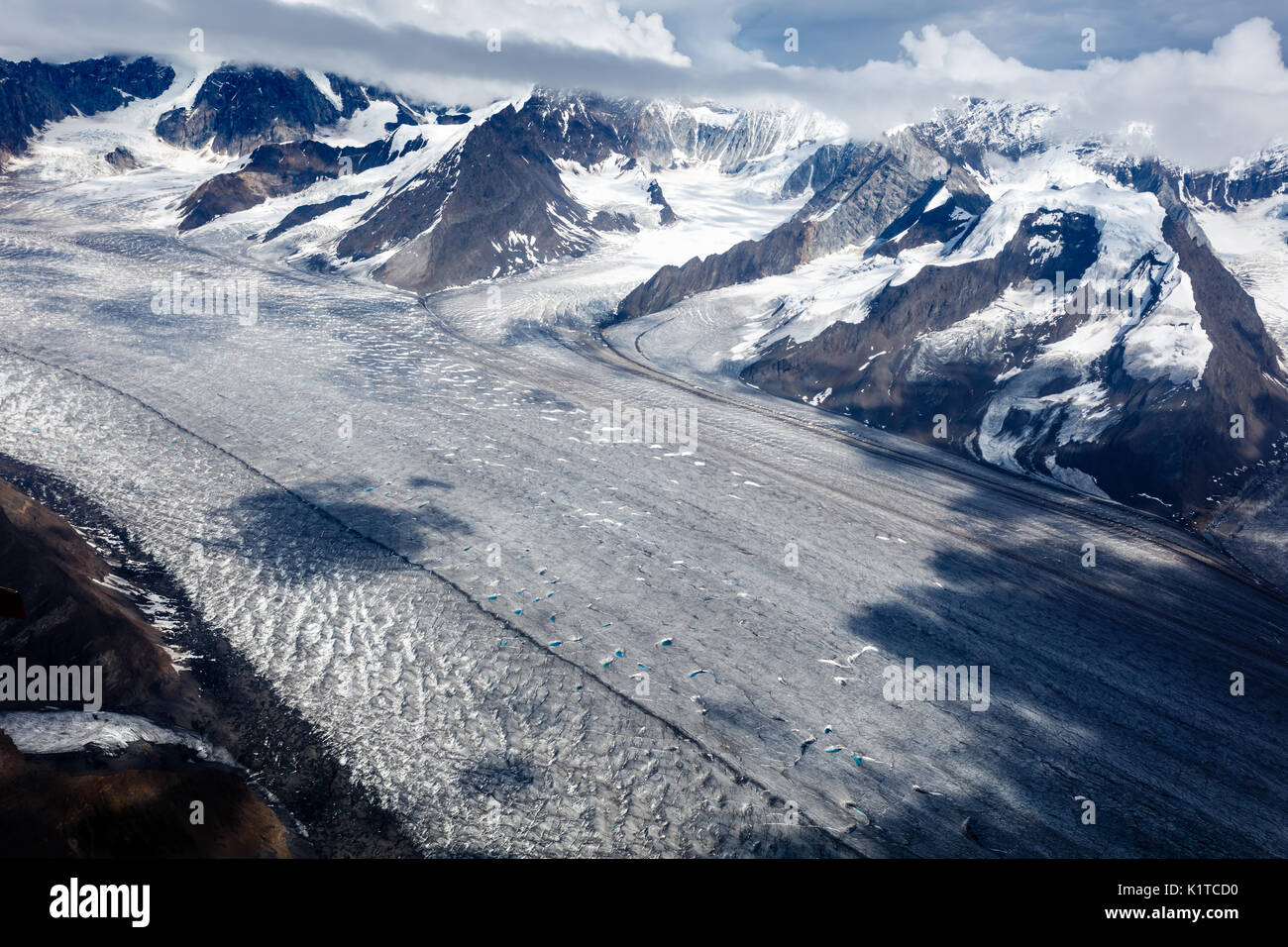 Aerial of glacier flow and crevasses that look like a smooth highway ...