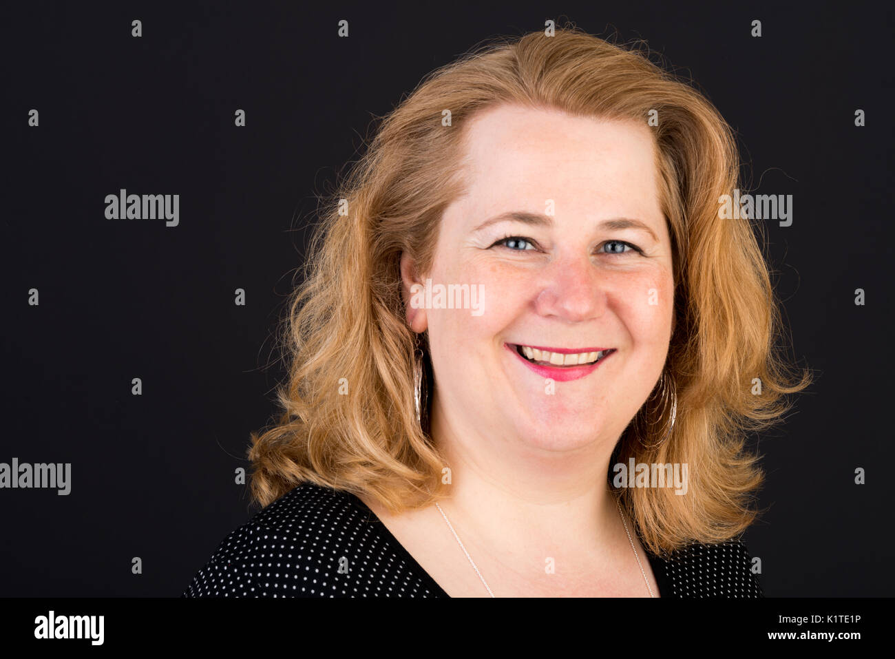 headshot portrait of attractive european girl in front of dark b Stock ...