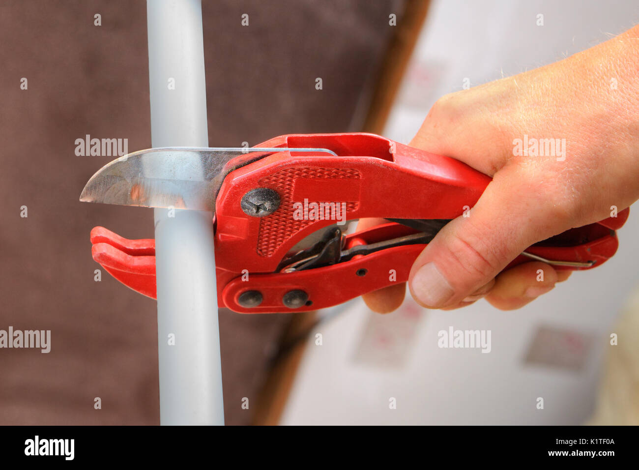 Using a cutter for plastic pipes in the repair of household water ...