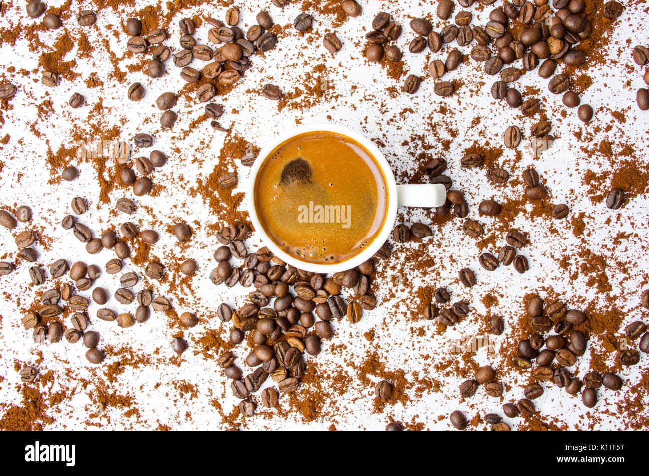 Cup of coffee with grains and powder on white flat lay Stock Photo - Alamy