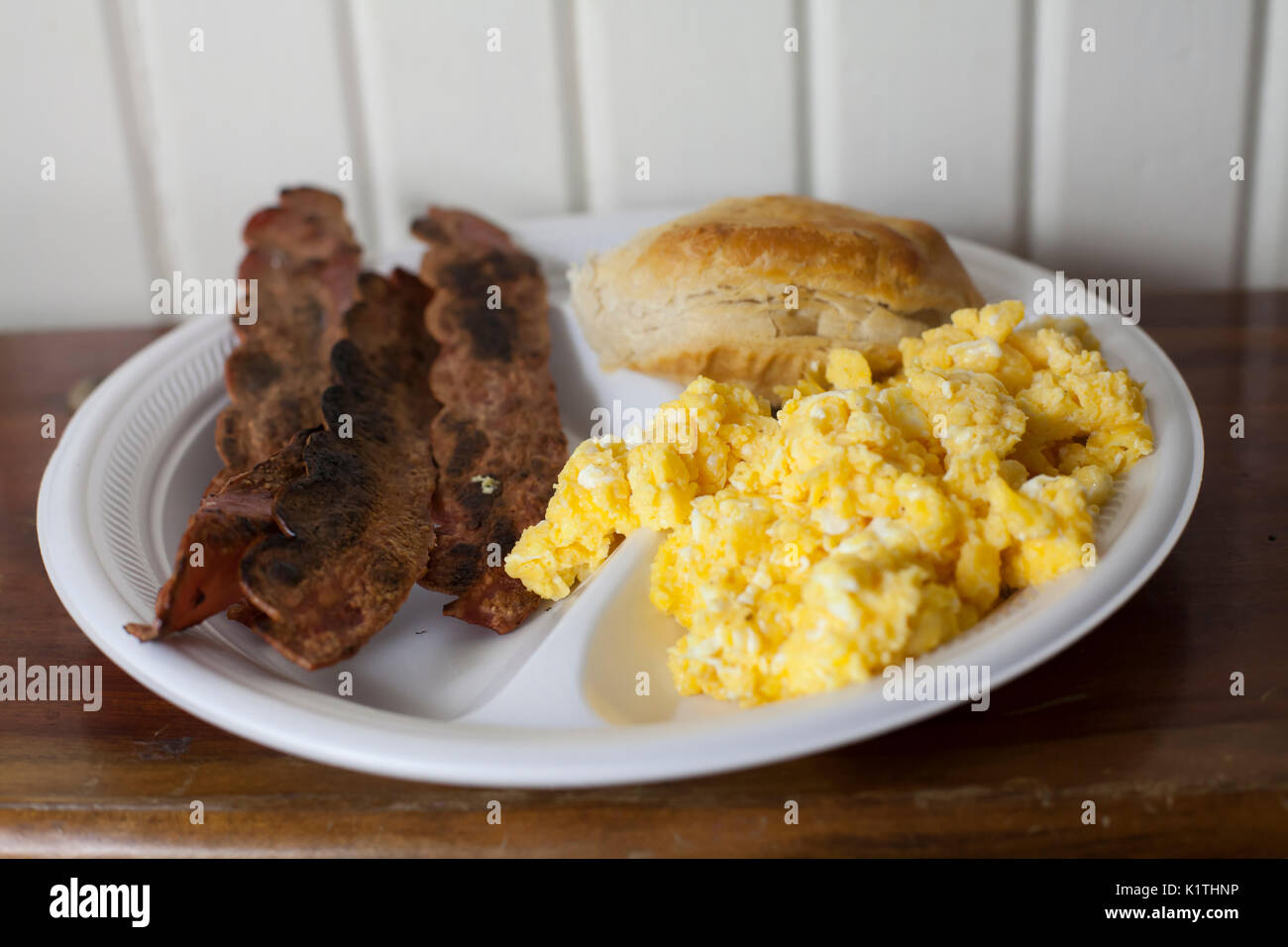 Breakfast plate filled with bacon, eggs and biscuit Stock Photo - Alamy