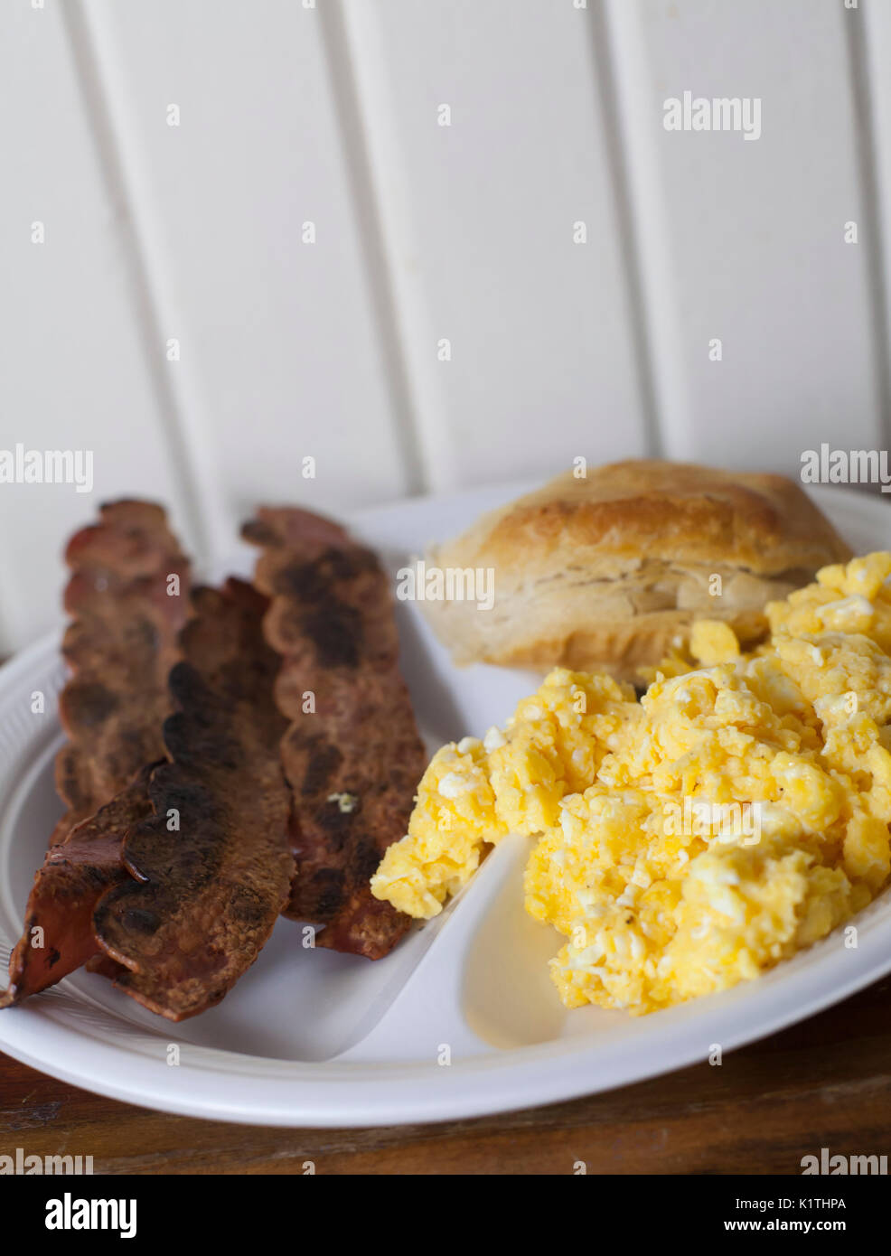 Breakfast plate filled with bacon, eggs and biscuit Stock Photo - Alamy
